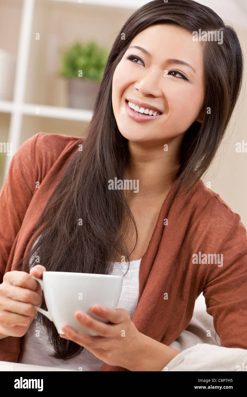 A beautiful happy young Chinese Asian Oriental woman with a wonderful ...