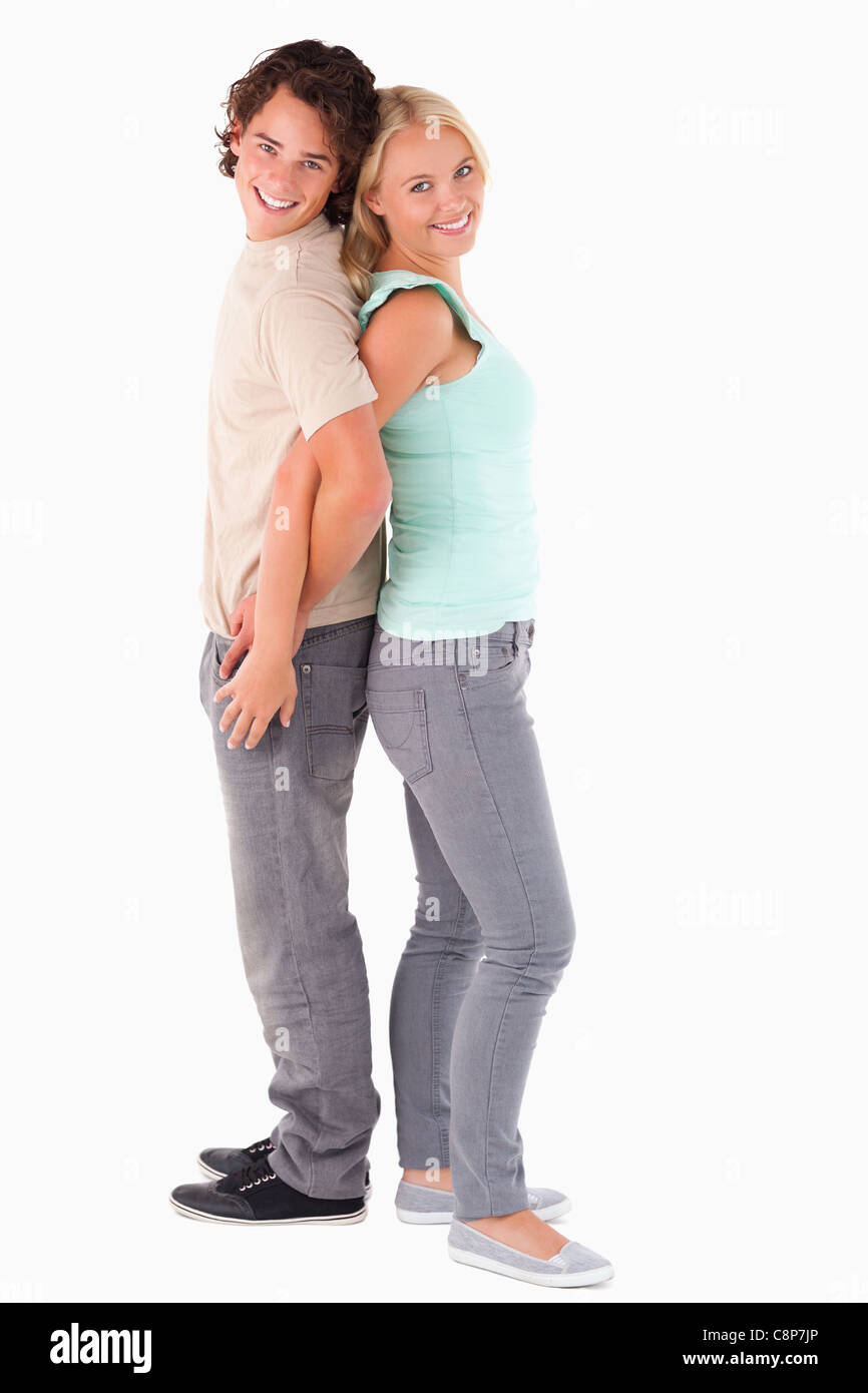 Happy couple standing back to back Stock Photo - Alamy