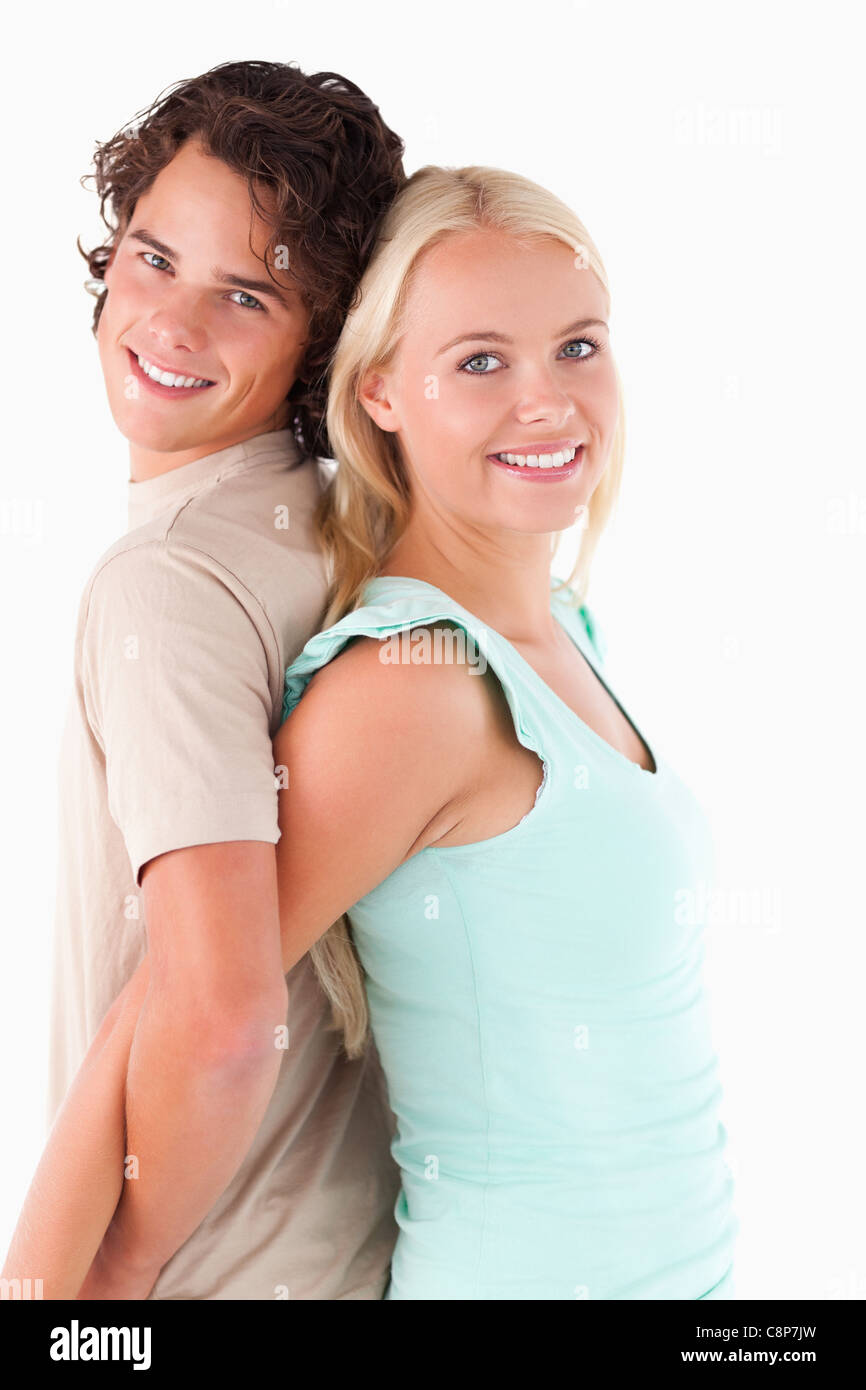 Close up of a Happy couple standing back to back Stock Photo - Alamy
