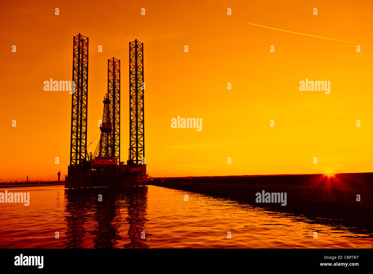 Oil rig at sunset background Stock Photo - Alamy