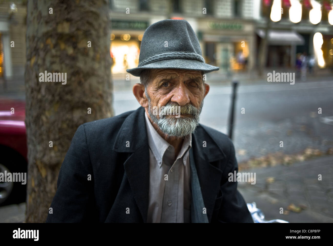 Poor old man in the street of Paris Stock Photo - Alamy
