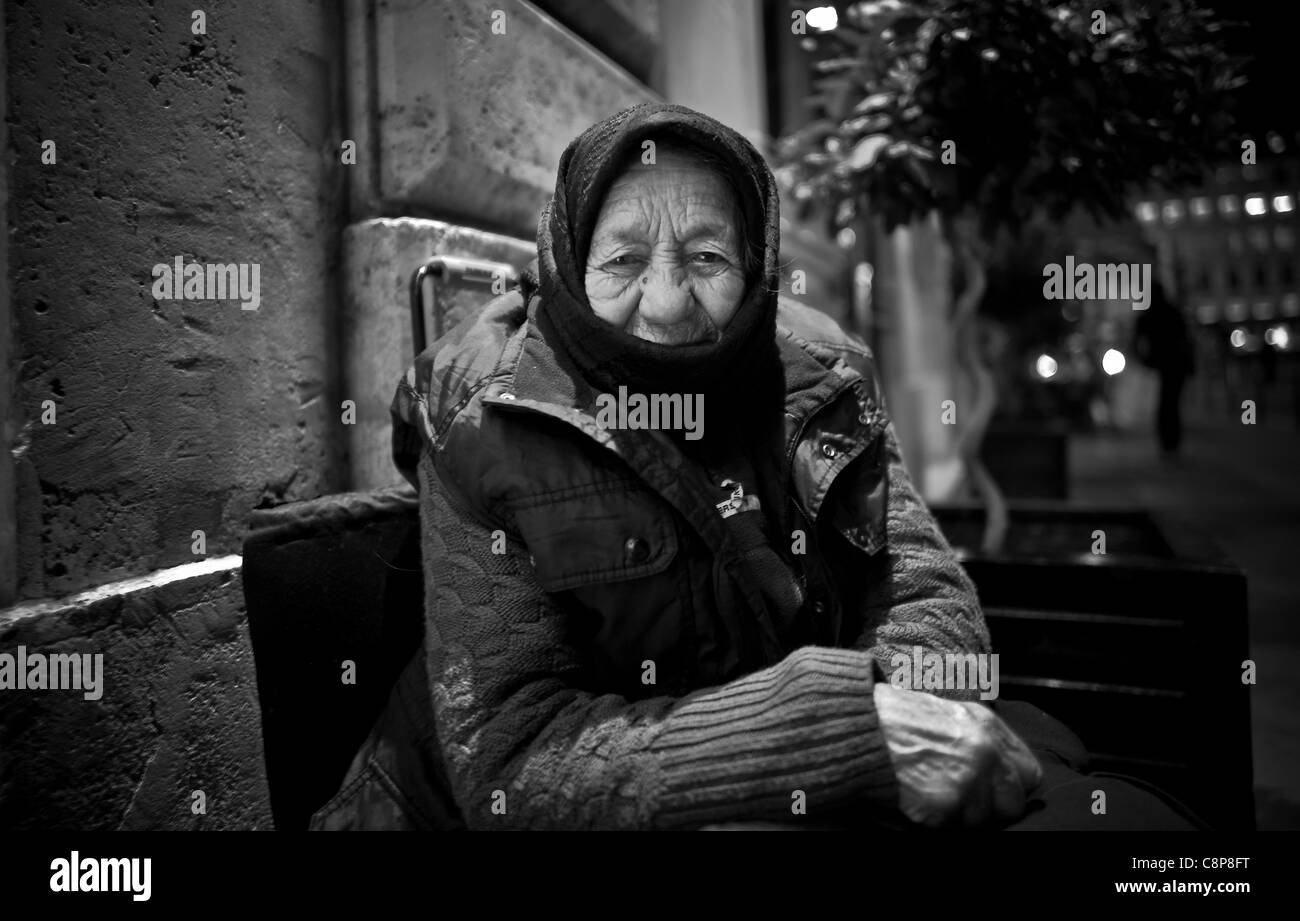 Urban Misery, Woman Roma living on the sidewalk near the Madeleine ...