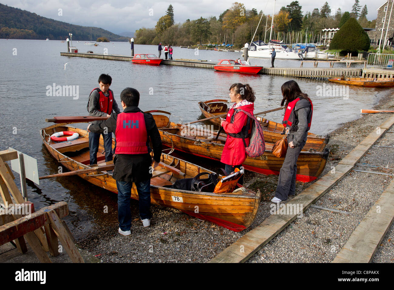 Japanese tourists getting ready to use a wooden rowing boat on Lake ...