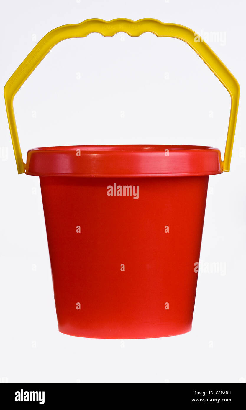 A bright red plastic child's bucket with a yellow handle Stock Photo ...