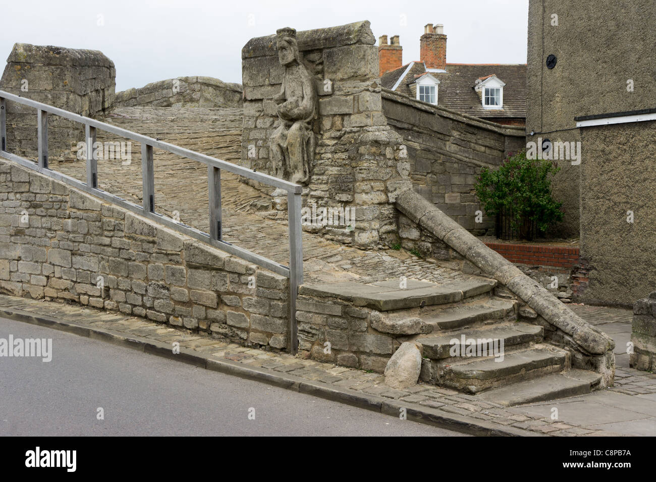 Trinity Bridge, Crowland, Linclonshire, England, UK. The seated figure ...
