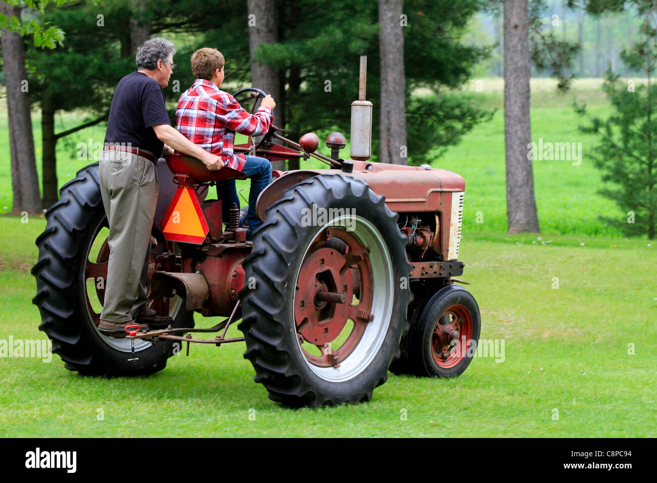 Grandfather teaching his Grandson how to drive a stick shift on a Old ...