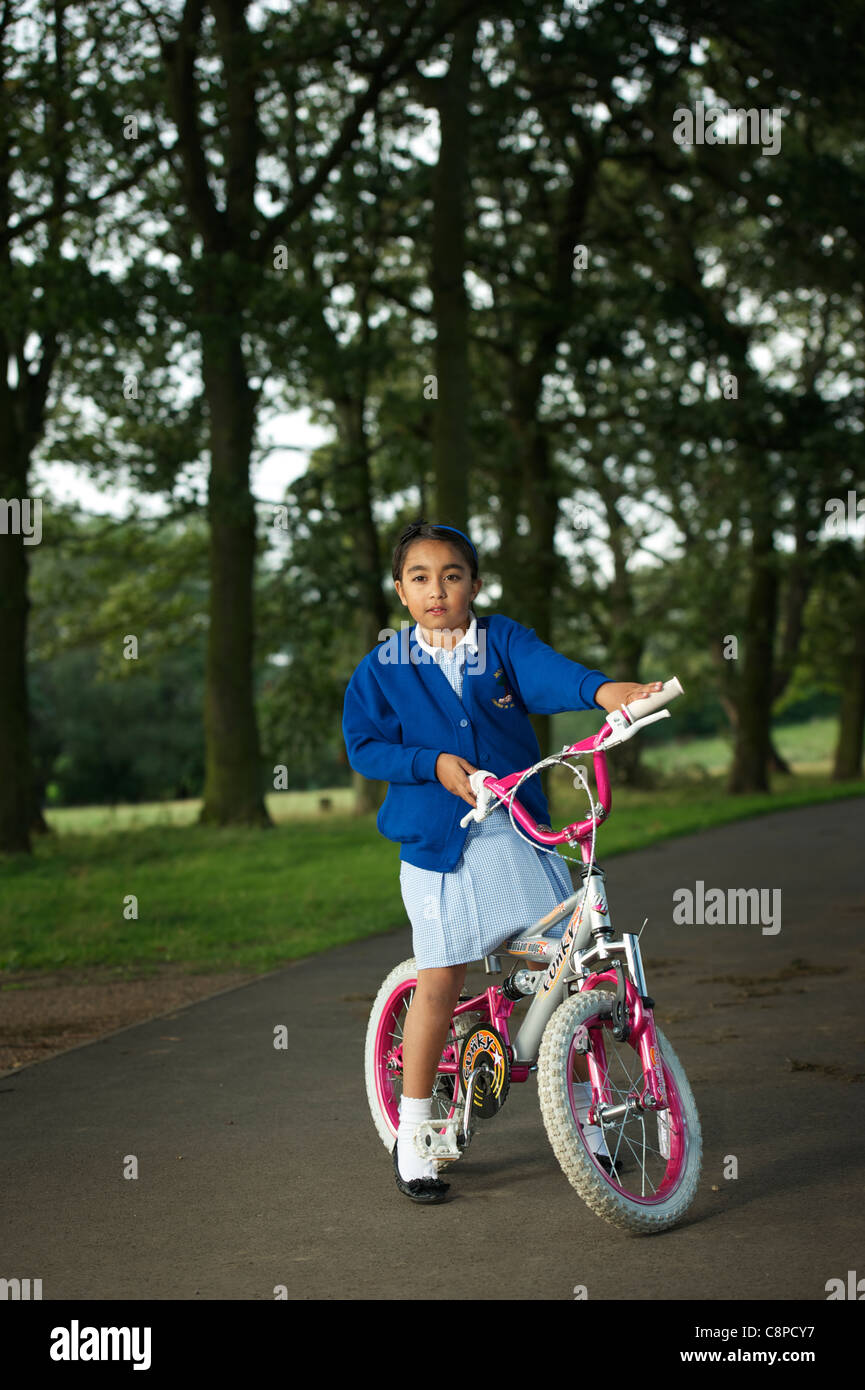 A young school girl cycling Stock Photo - Alamy