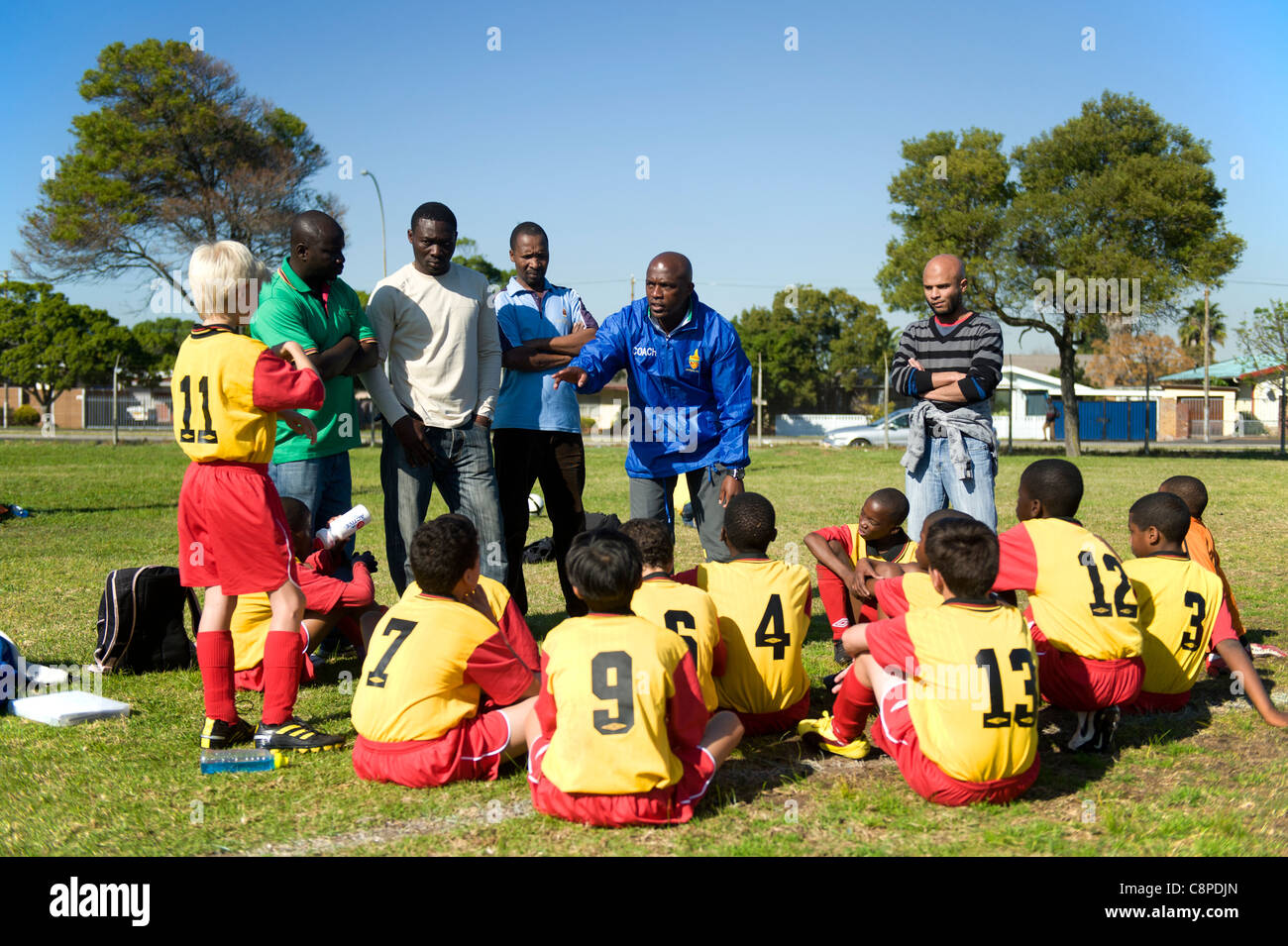 Football coach instructs junior team during half-time break Cape Town ...