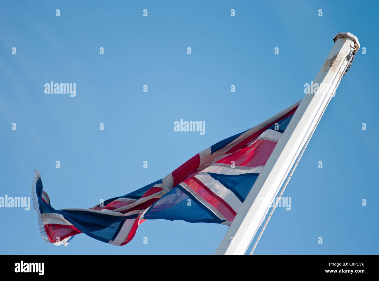 Close Up of a Union Jack Flag, Half Furled, Blowing in the Wind Against ...