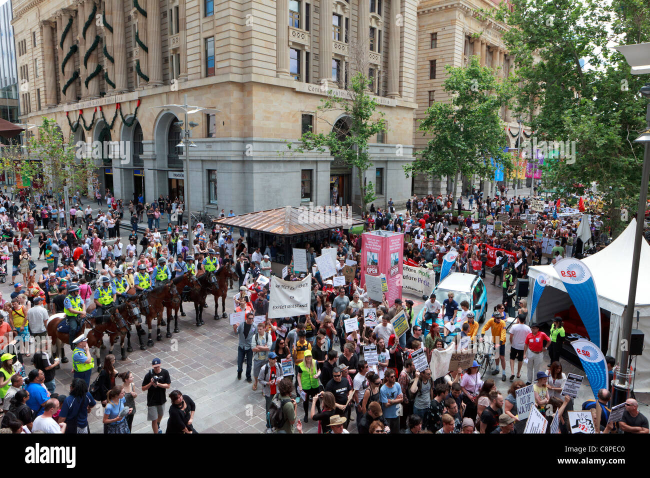 Occupy Perth protesters march past mounted police. The protest was held ...