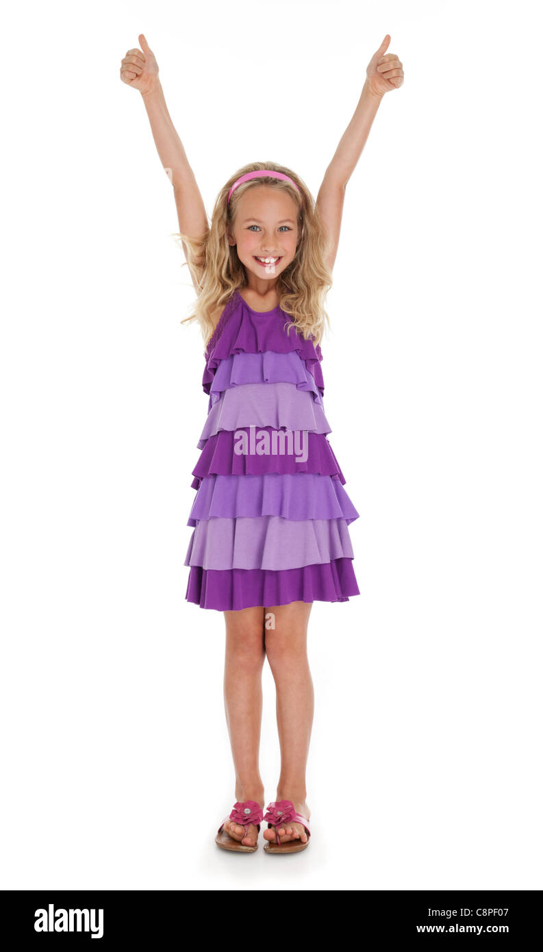 Pretty seven year old girl with arms extended overhead giving thumbs up ...
