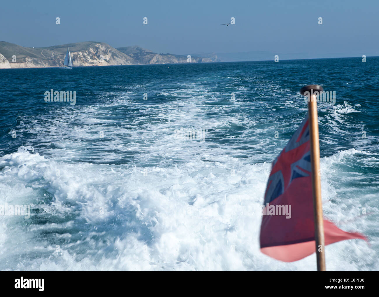 flag off the back on the boat on Jurassic coast Stock Photo - Alamy