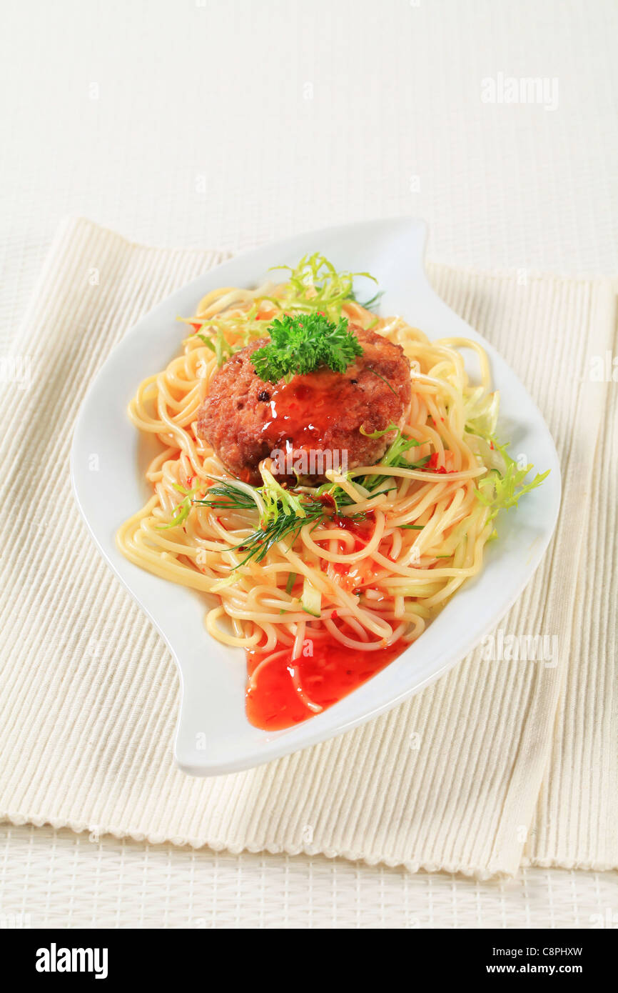 Meat patty with spaghetti and spicy sauce Stock Photo - Alamy