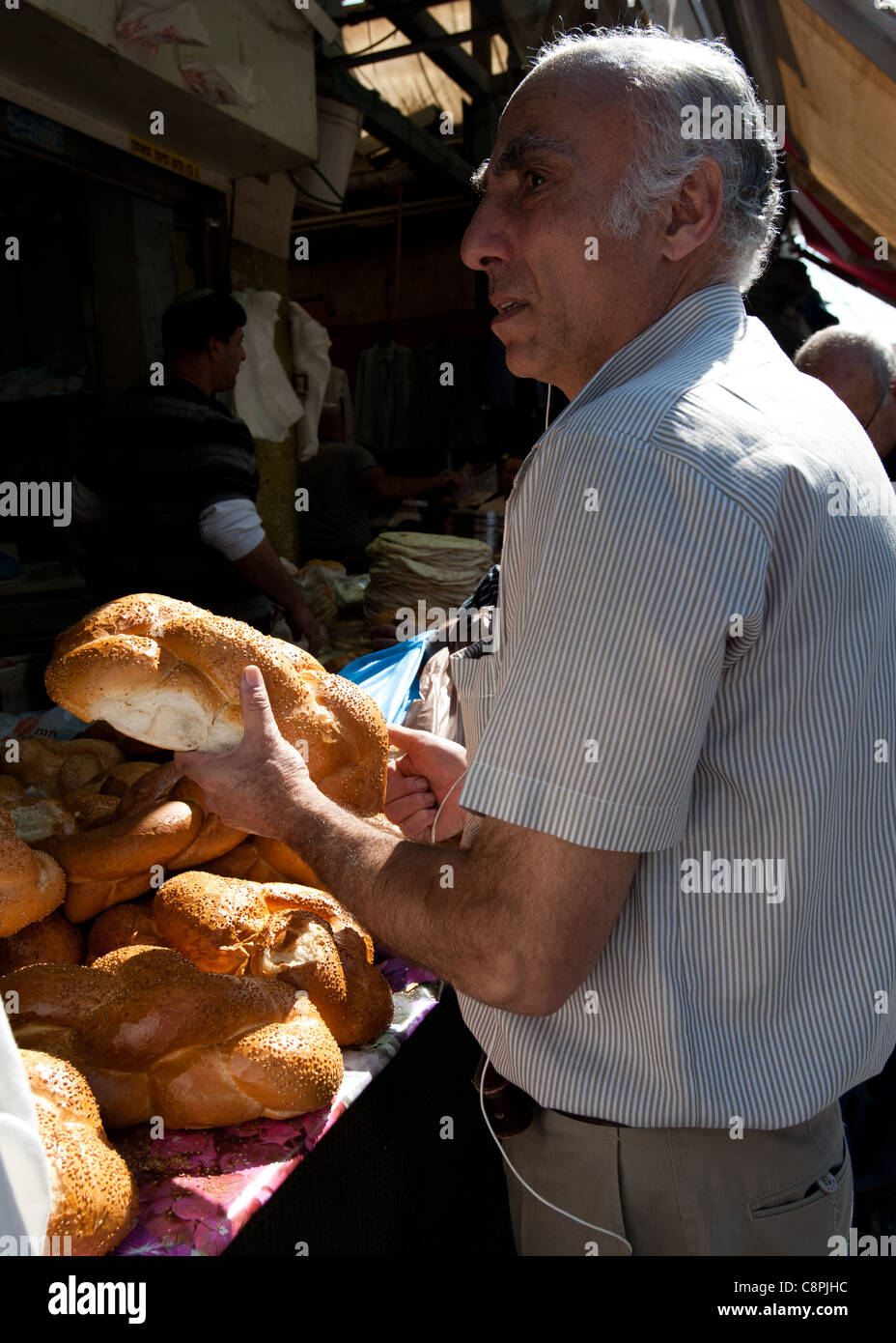 A man buying Hala bread for Shabat, Friday morning at Machne Yehuda ...