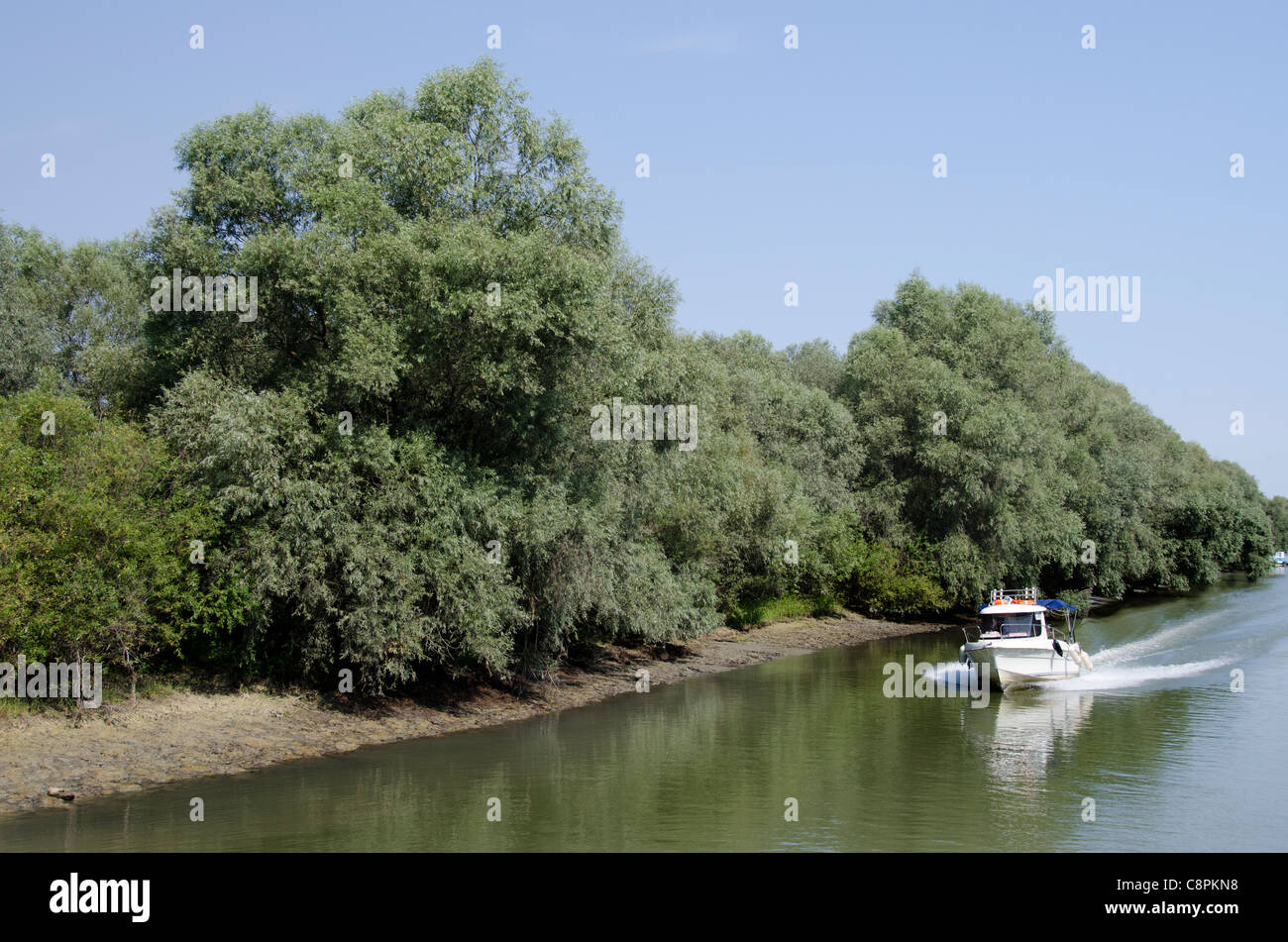 Romania, Dobrudgea region, Tulcea, Danube Delta. Sulina channel lined ...