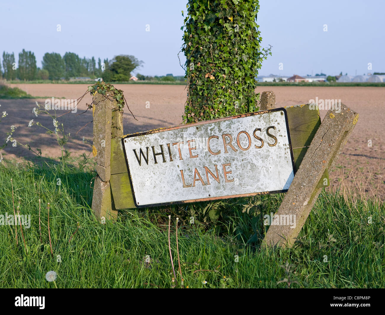 A neglected name board at beginning of a country lane Stock Photo - Alamy