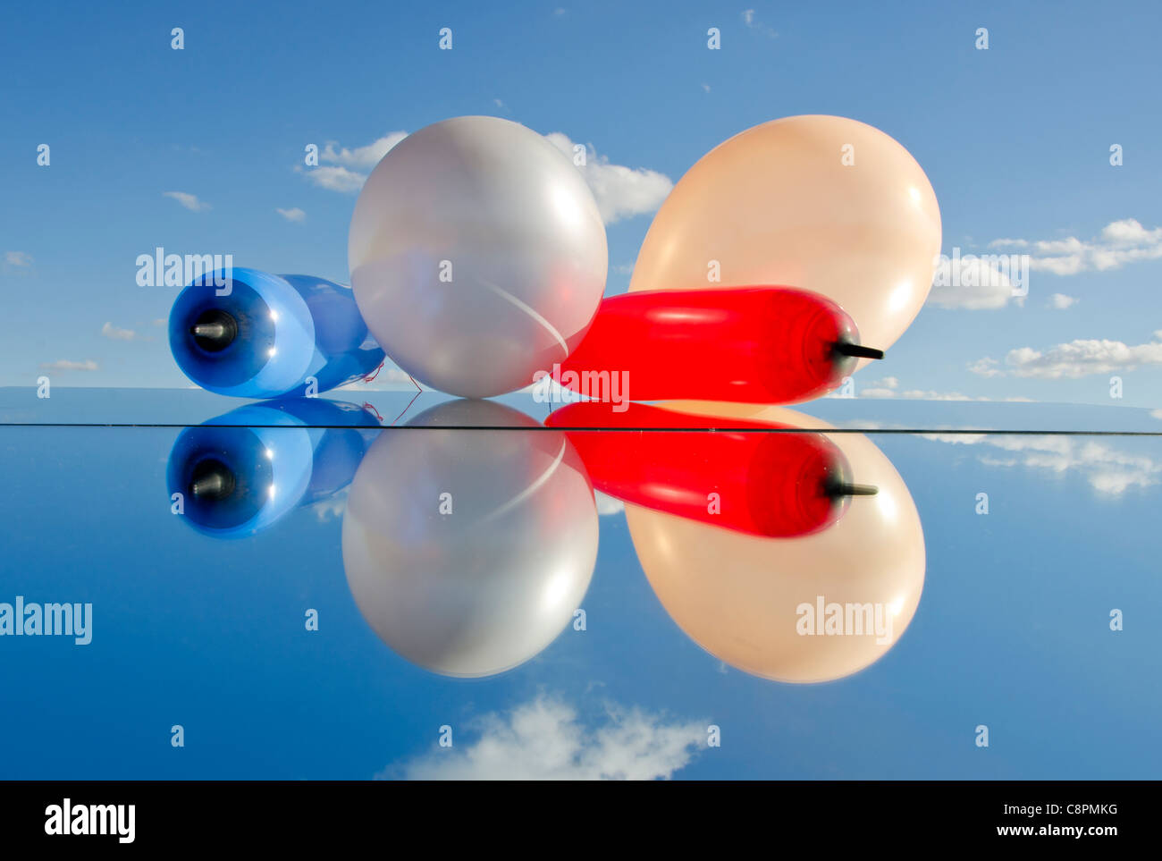 various balloons on mirror and sky Stock Photo - Alamy