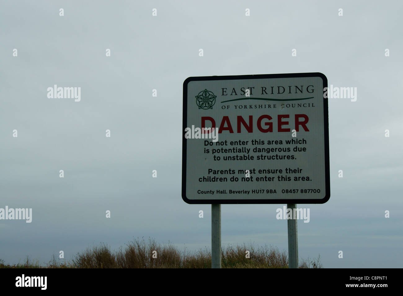 Coastal erosion warning sign on the east coast of Yorkshire near Spurn ...