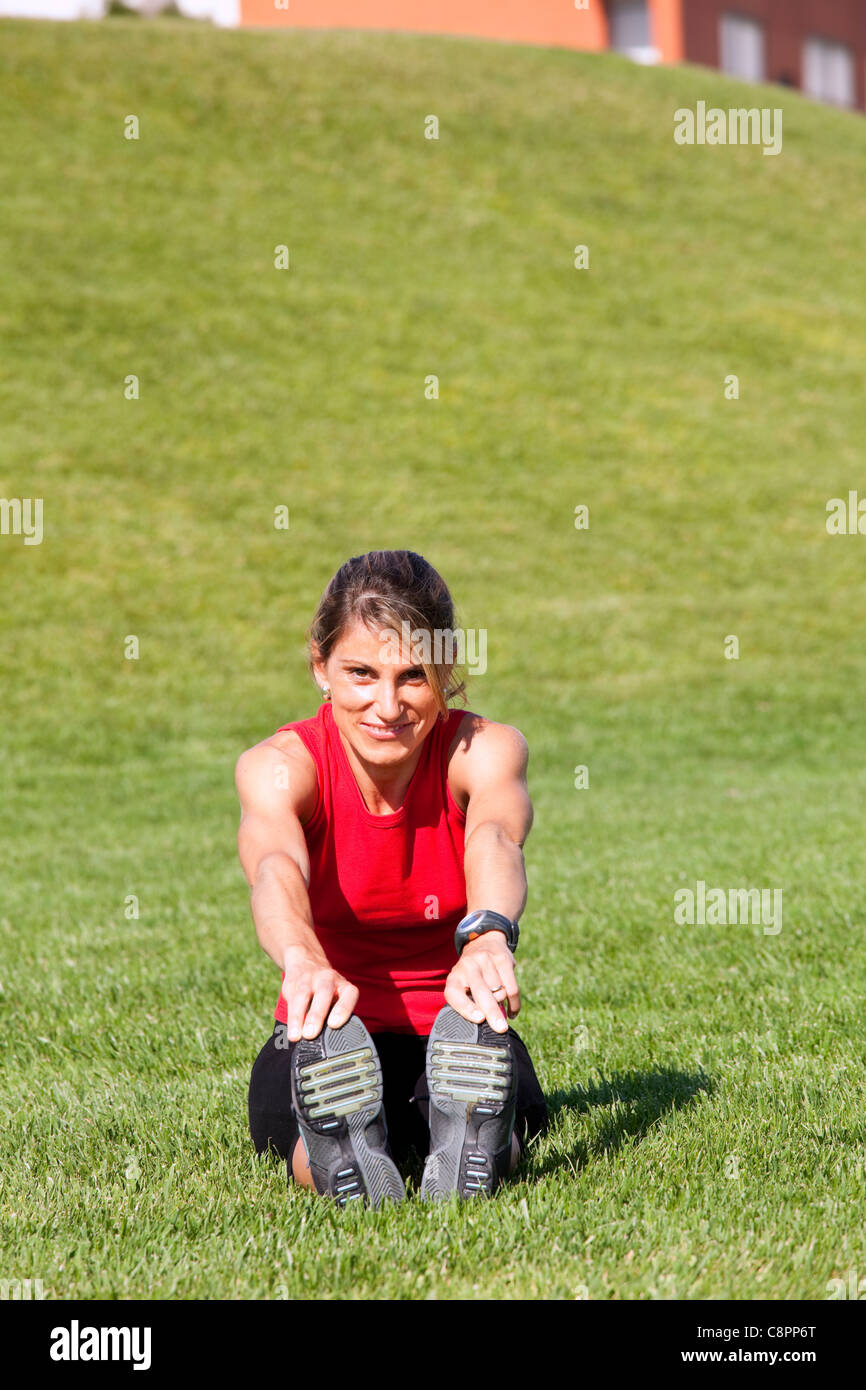 young woman doing some exercise at the park Stock Photo - Alamy