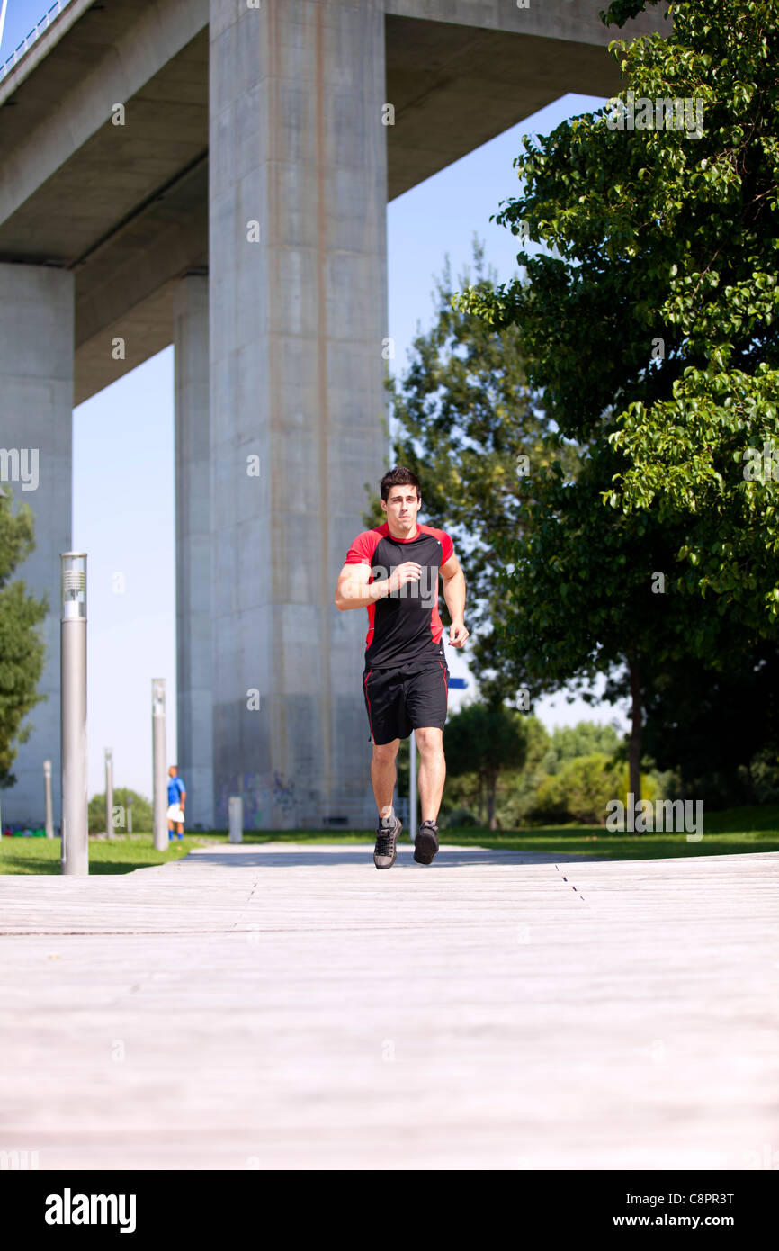 Men athlete running at the city park Stock Photo - Alamy