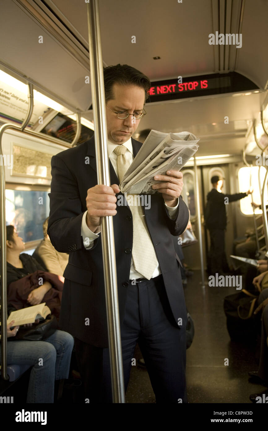Reading the newspaper subway hi-res stock photography and images - Alamy