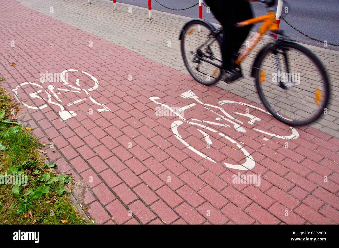 bicycle track with signs and bicycle wheels in motion Stock Photo - Alamy