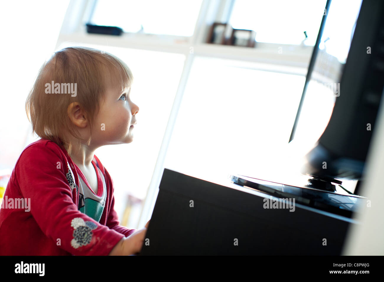 Toddler watching television Stock Photo - Alamy