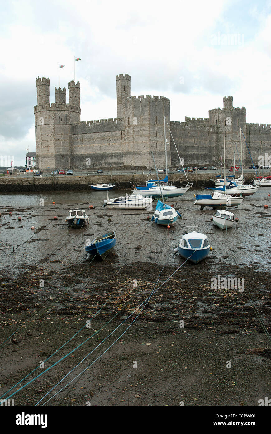 Great Britain, Wales, Caernarfon Castle with boats at low tide in the ...