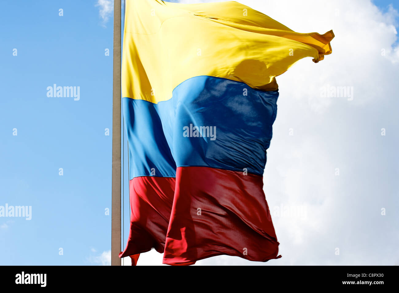 The yellow, blue and red of the Colombian flag billowing in the wind ...