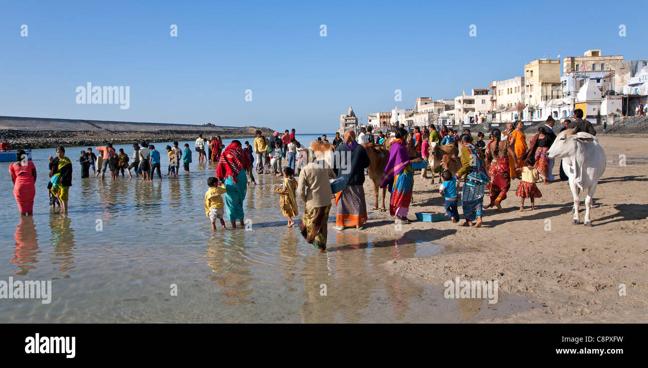 Hindu pilgrims taking a holy dip. Dwarka. Gujarat. India Stock Photo ...