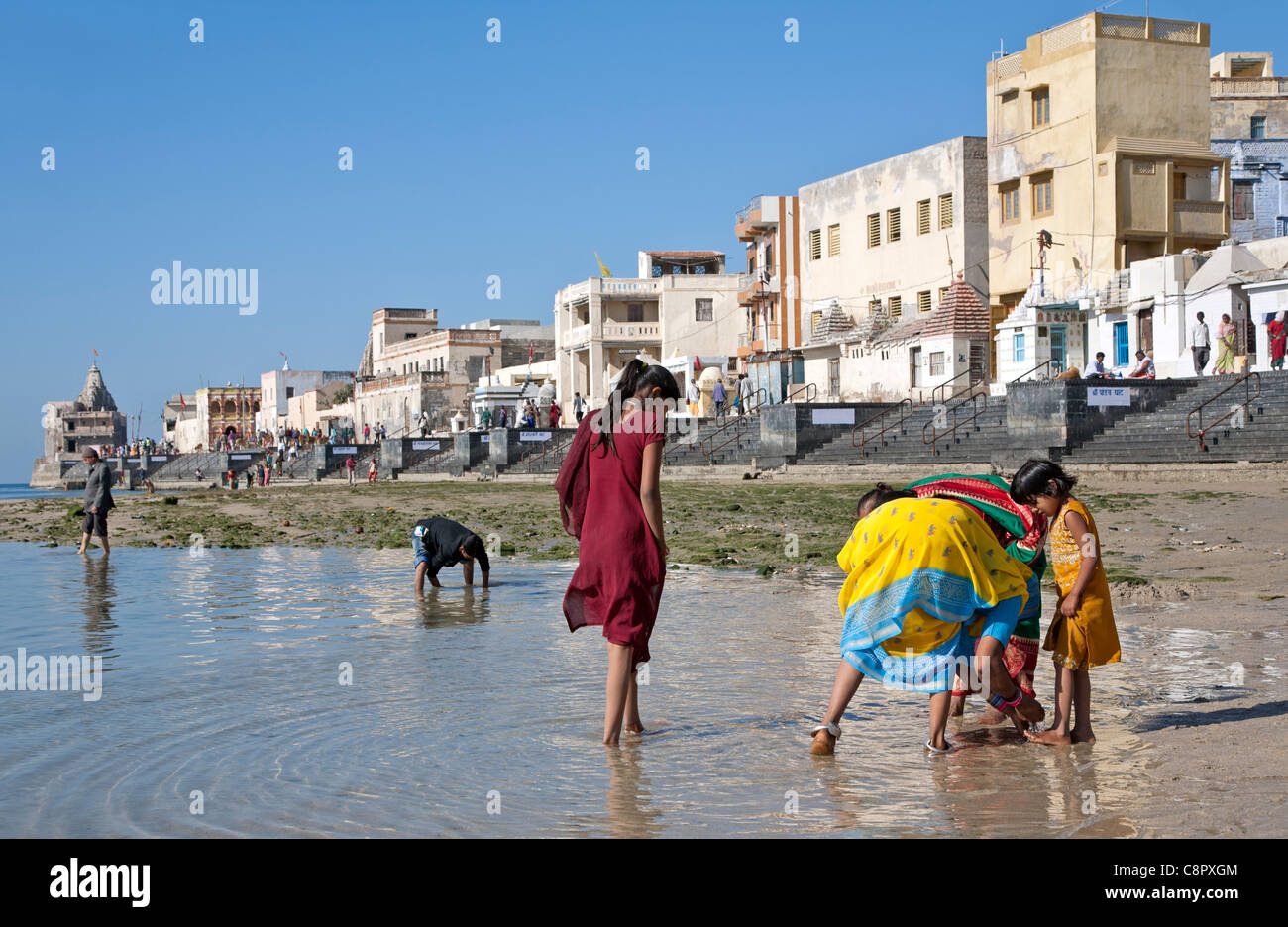 Mother washing the feet of her daughter (hindu ritual). Dwarka. Gujarat ...