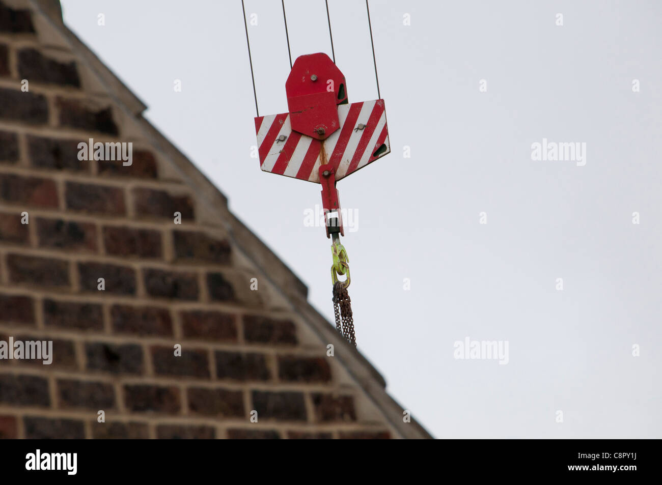 crane hook moving behind a house Stock Photo - Alamy