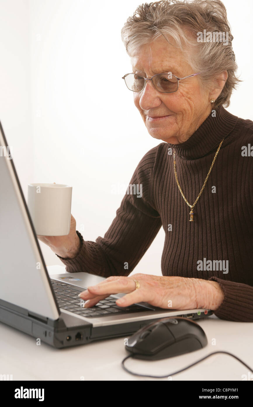 An Elderly woman using a laptop Stock Photo - Alamy