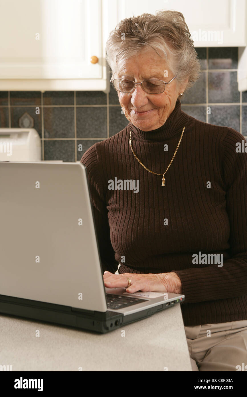 Old woman using her laptop at home Stock Photo - Alamy