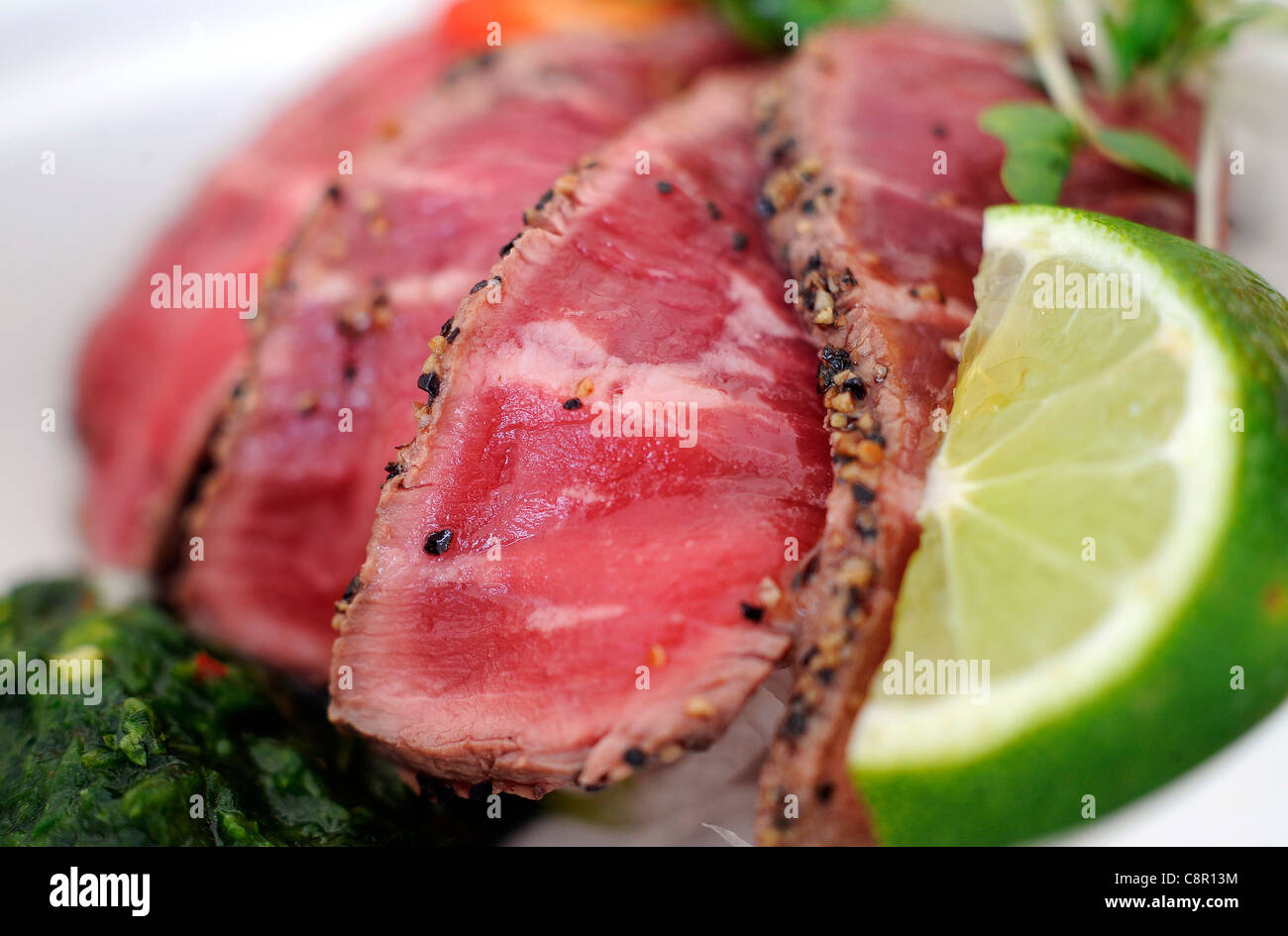 Close up view of seared tuna with a lime dressing Stock Photo - Alamy
