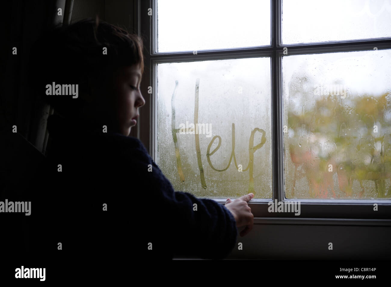 Boy peeking through window hi-res stock photography and images - Alamy