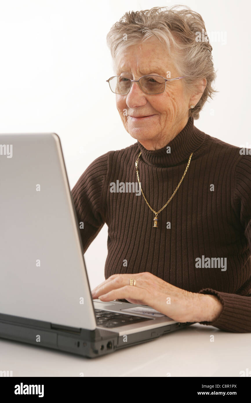 A happy old lady using a laptop Stock Photo - Alamy