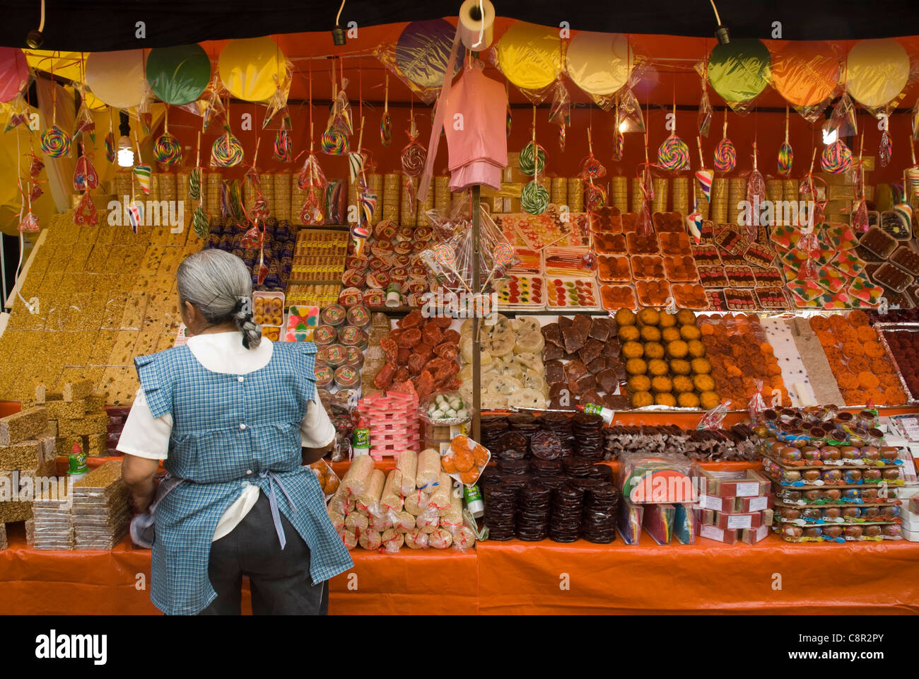 Woman selling sweets at a fare in Mexico Stock Photo - Alamy