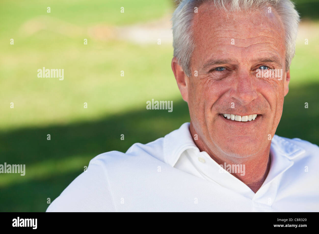 Happy and healthy senior man sitting outside smiling and happy Stock ...