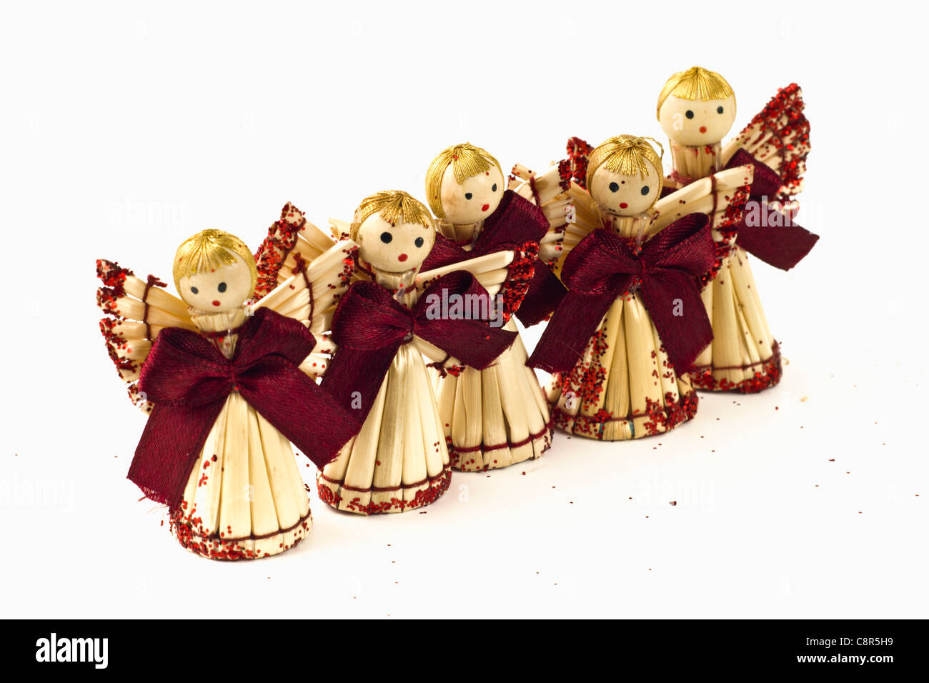 Five Christmas angels in row, diagonally, on white background Stock ...