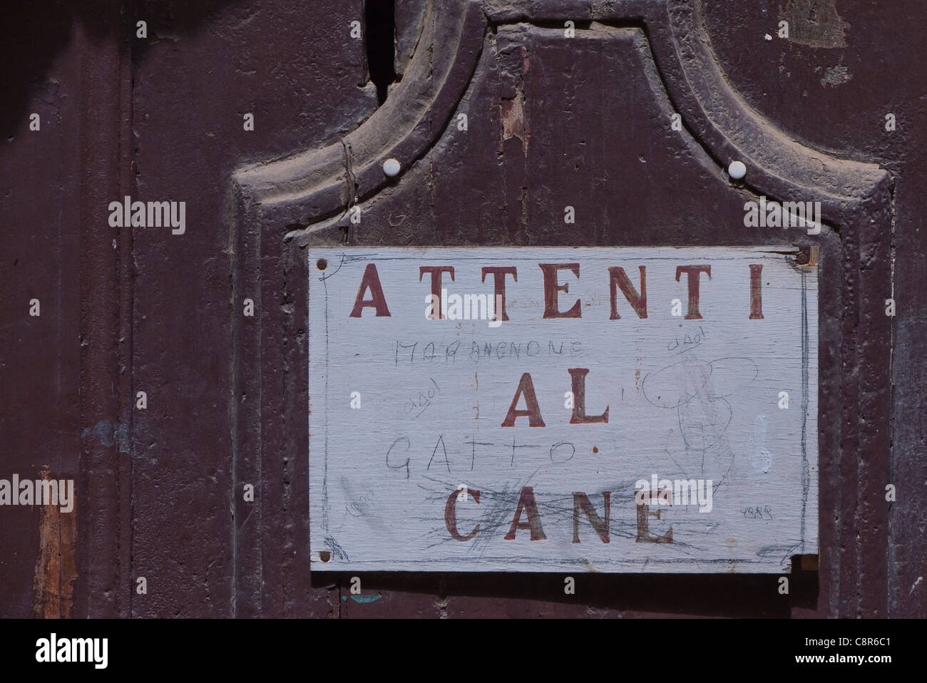 A warning sign for a dog stating "Attenti al Cane" in Italian, where ...