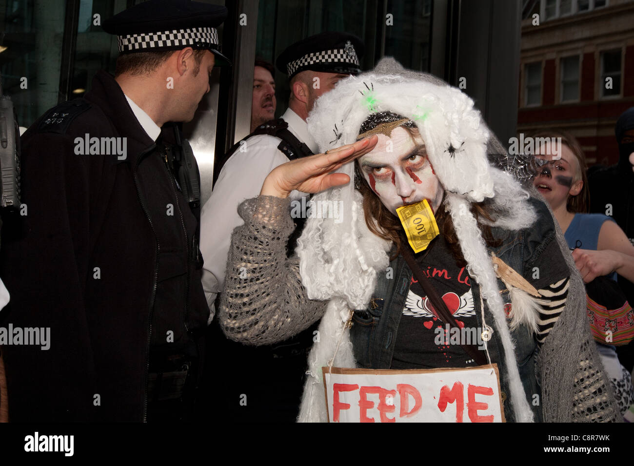 London, UK, 31/10/2011. Girl activist dressed as a zombie saluting ...