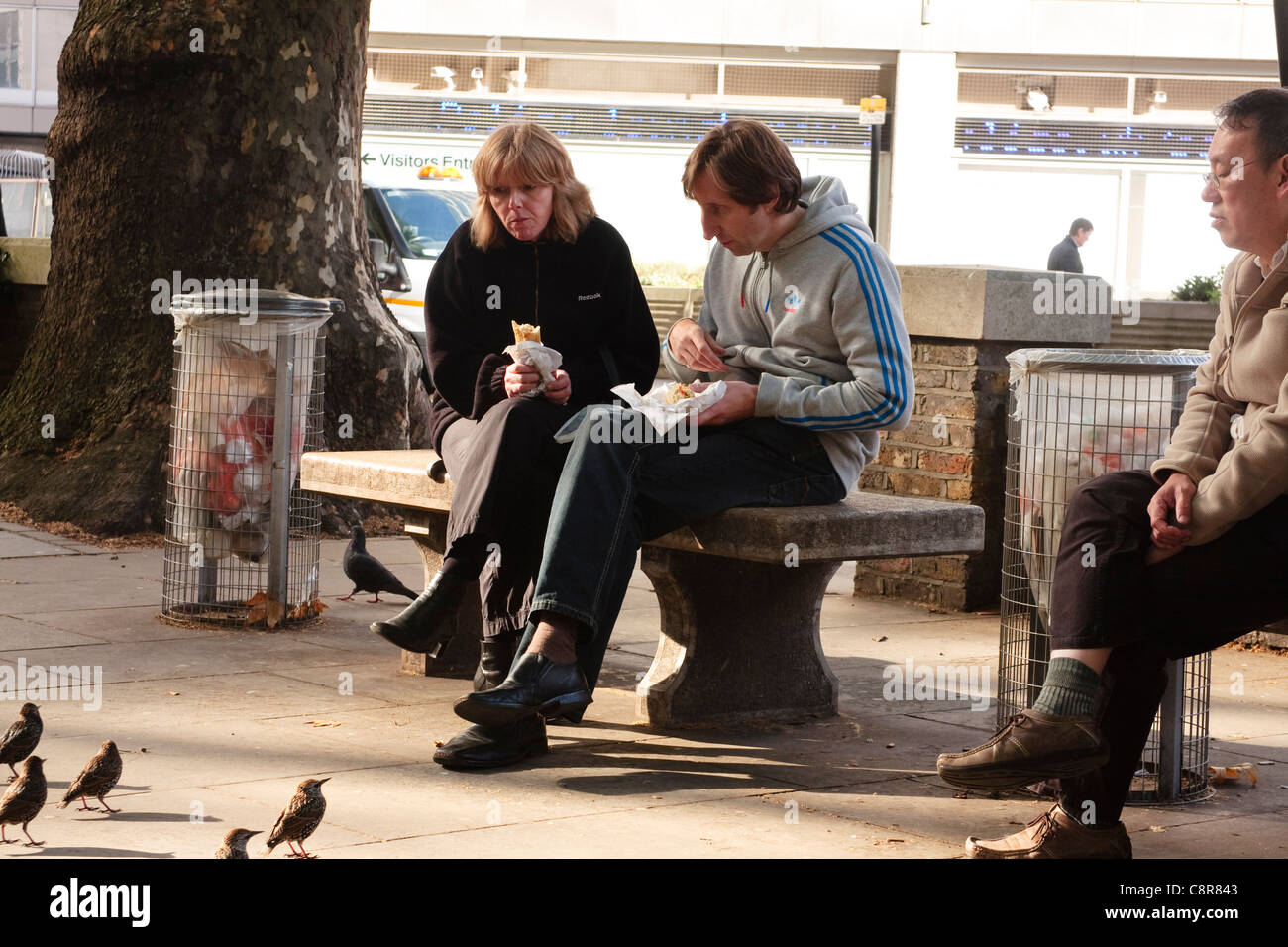 Two men on a bench eating hi-res stock photography and images - Alamy