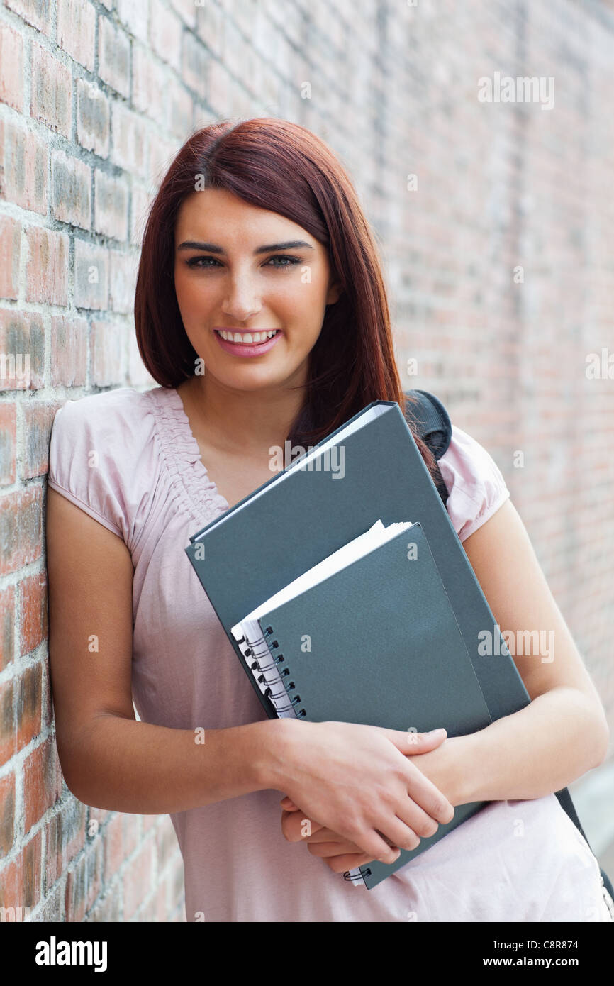 Portrait of a happy student holding her binders Stock Photo - Alamy