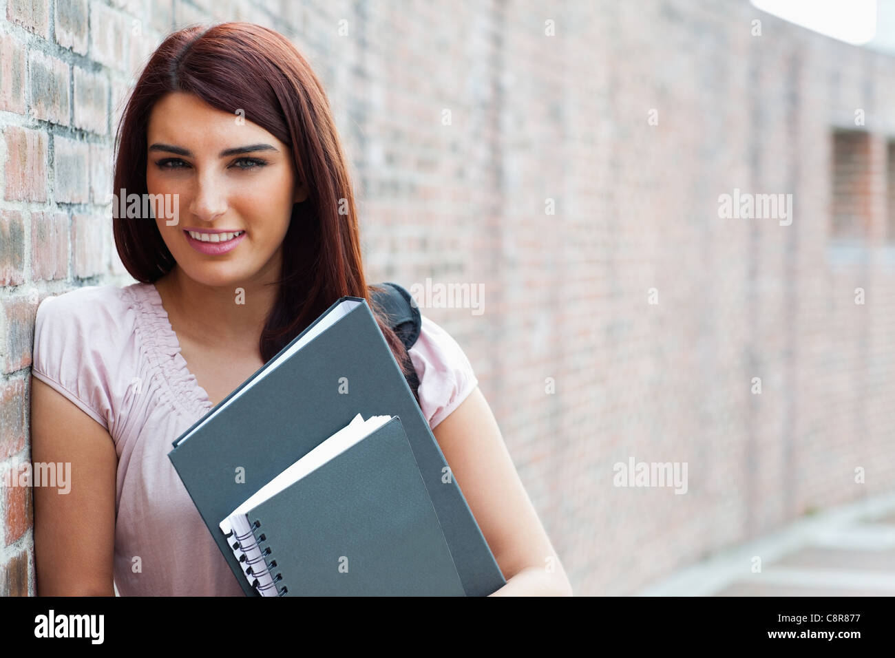 Happy student holding her binders Stock Photo - Alamy