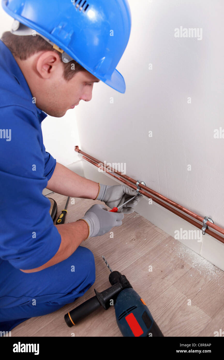 Plumber wearing gloves repairing hi-res stock photography and images - Alamy