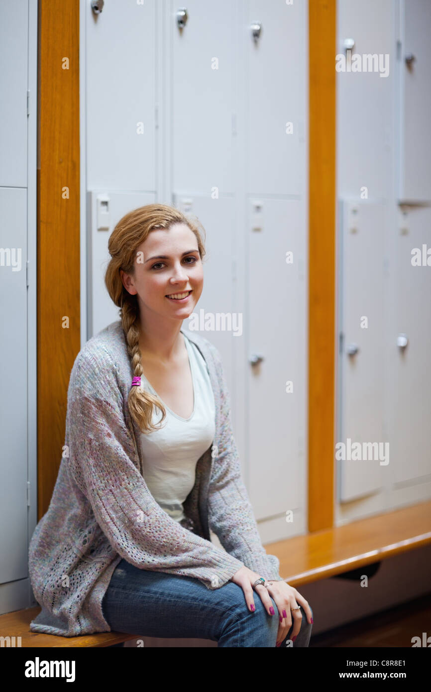 Portrait of a smiling student sitting on a bench Stock Photo - Alamy