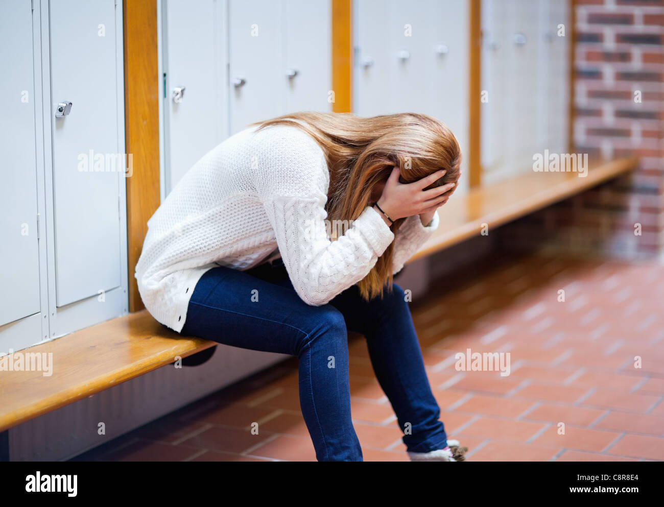 Depressed student sitting on a bench Stock Photo - Alamy