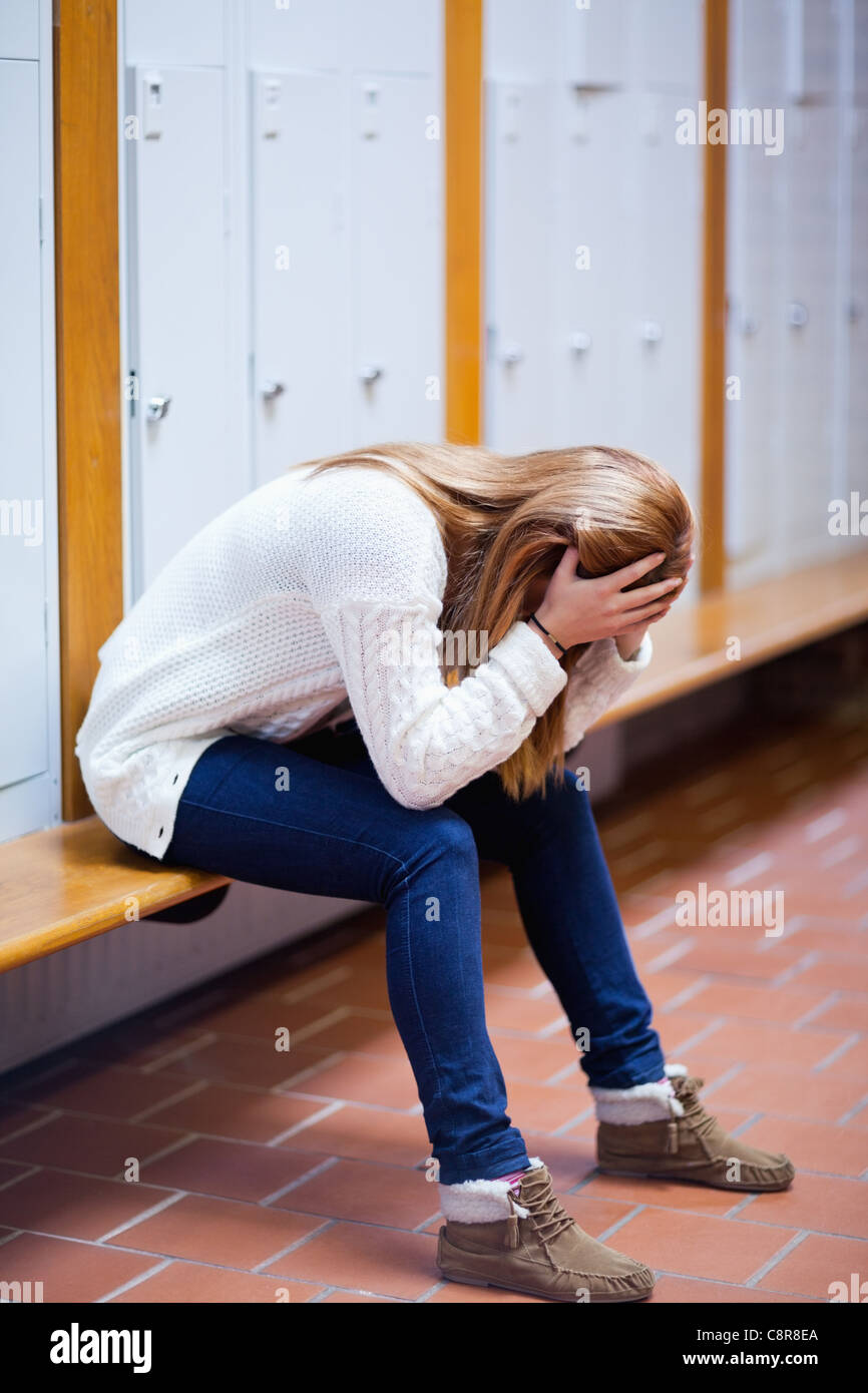 Portrait of a depressed student sitting on a bench Stock Photo - Alamy
