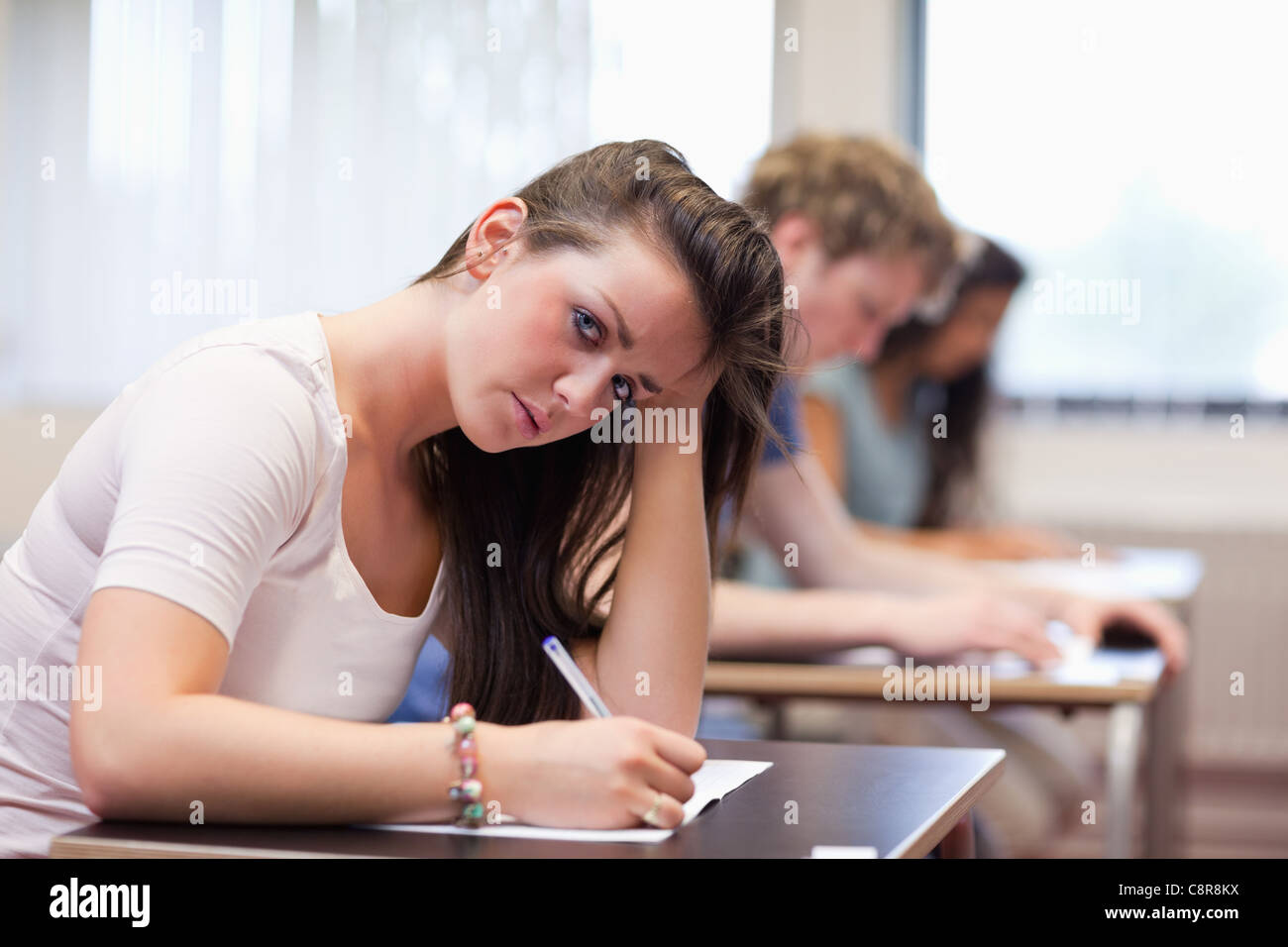 Serious woman writing Stock Photo - Alamy